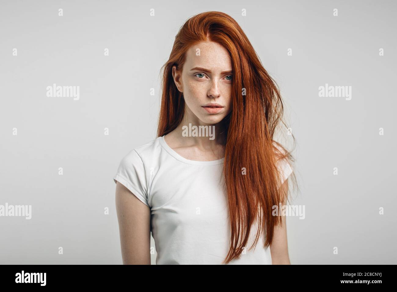 redhead teenage girl with healthy freckled skin looking at camera with ...
