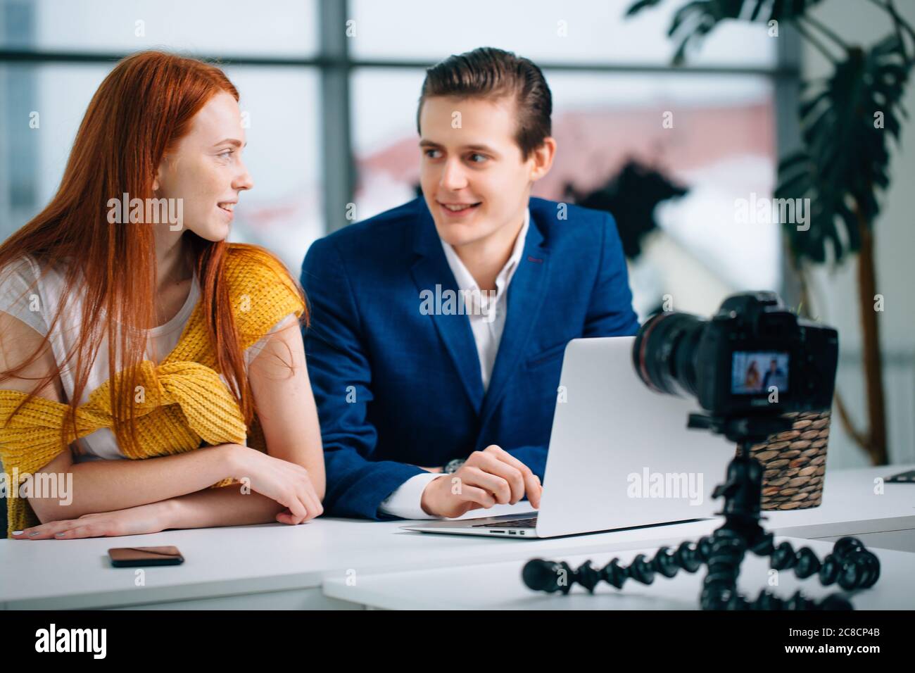 two video blogger talk about something and smiling Stock Photo - Alamy