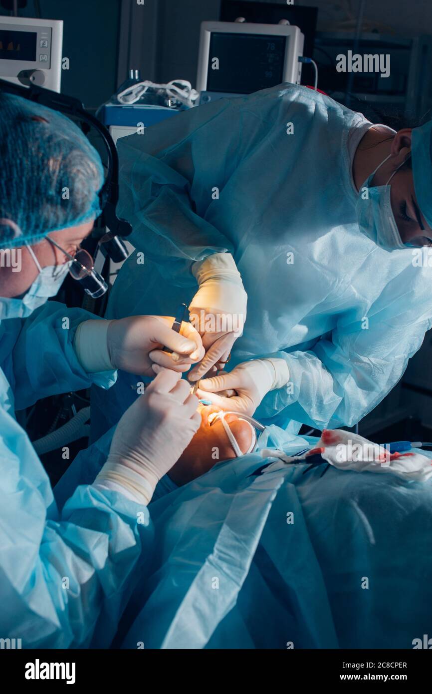 Another surgery. Surgery medical team operating in a surgery room of ...