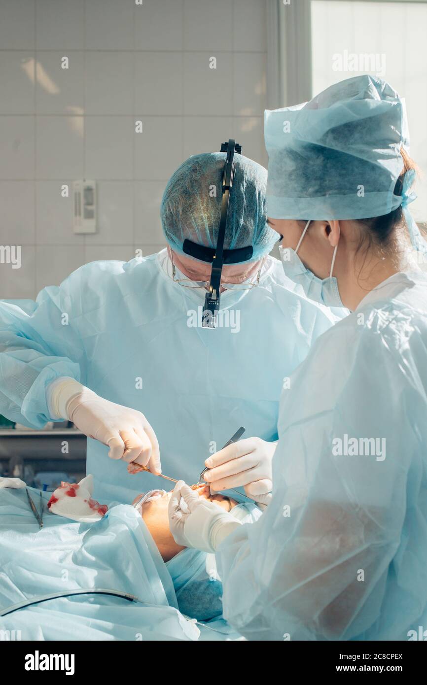 Another surgery. Surgery medical team operating in a surgery room of ...