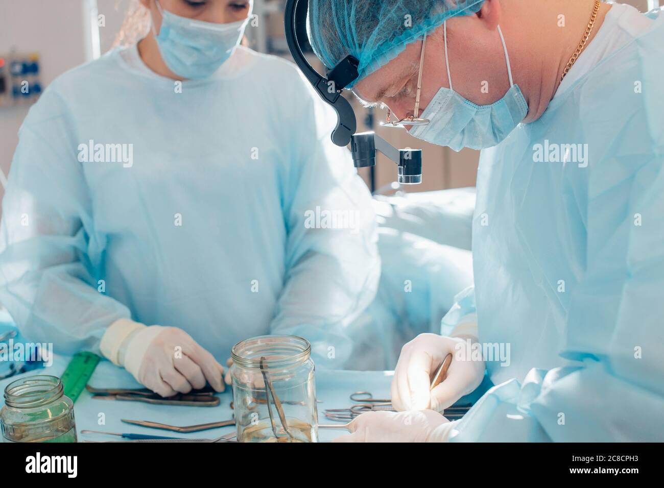 Team of surgeon in uniform perform operation on a patient at plastic ...