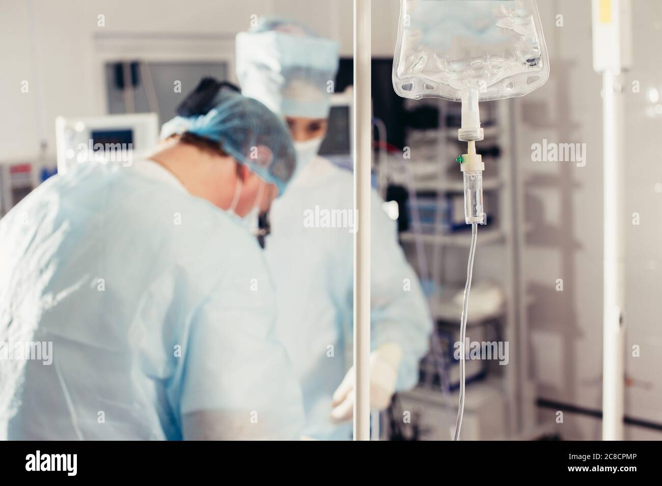 Doctor's hand and infusion drip in hospital on blurred background Stock ...