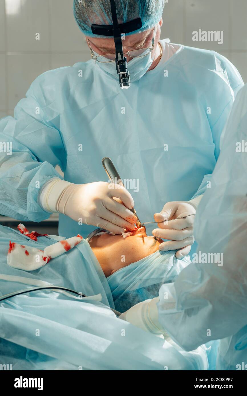 Surgeon operating live shot in surgery room Stock Photo - Alamy
