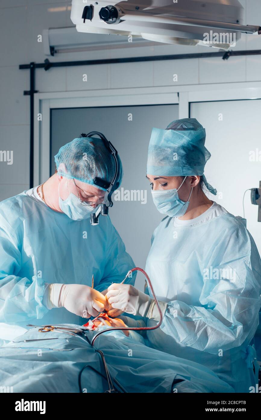 Another surgery. Surgery medical team operating in a surgery room of ...