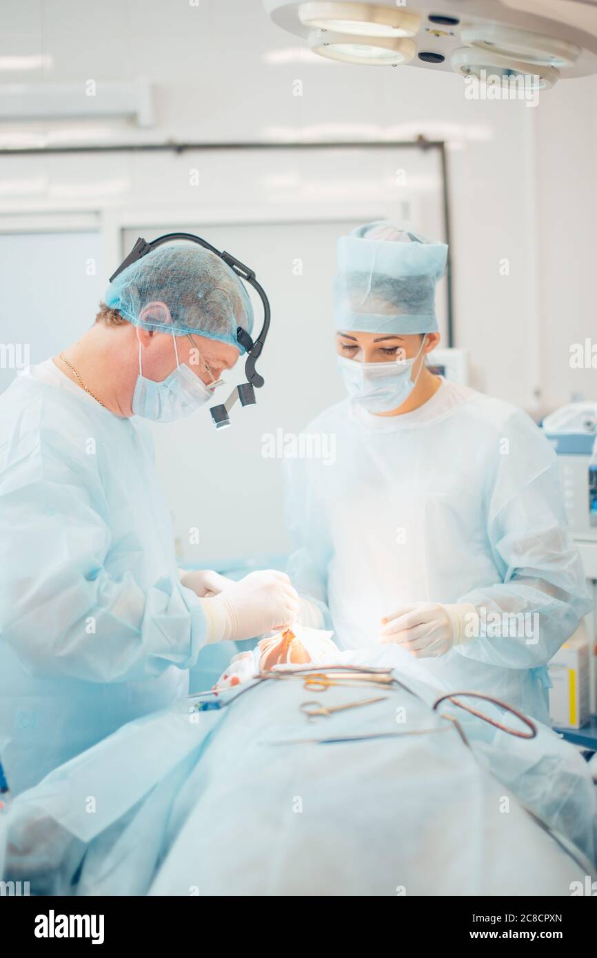 Another surgery. Surgery medical team operating in a surgery room of ...