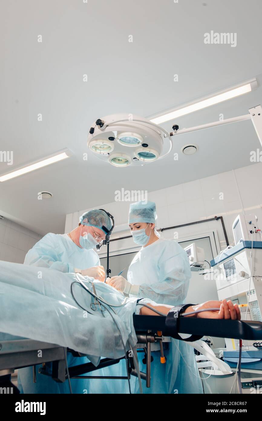 Woman lying on operating table hi-res stock photography and images - Alamy