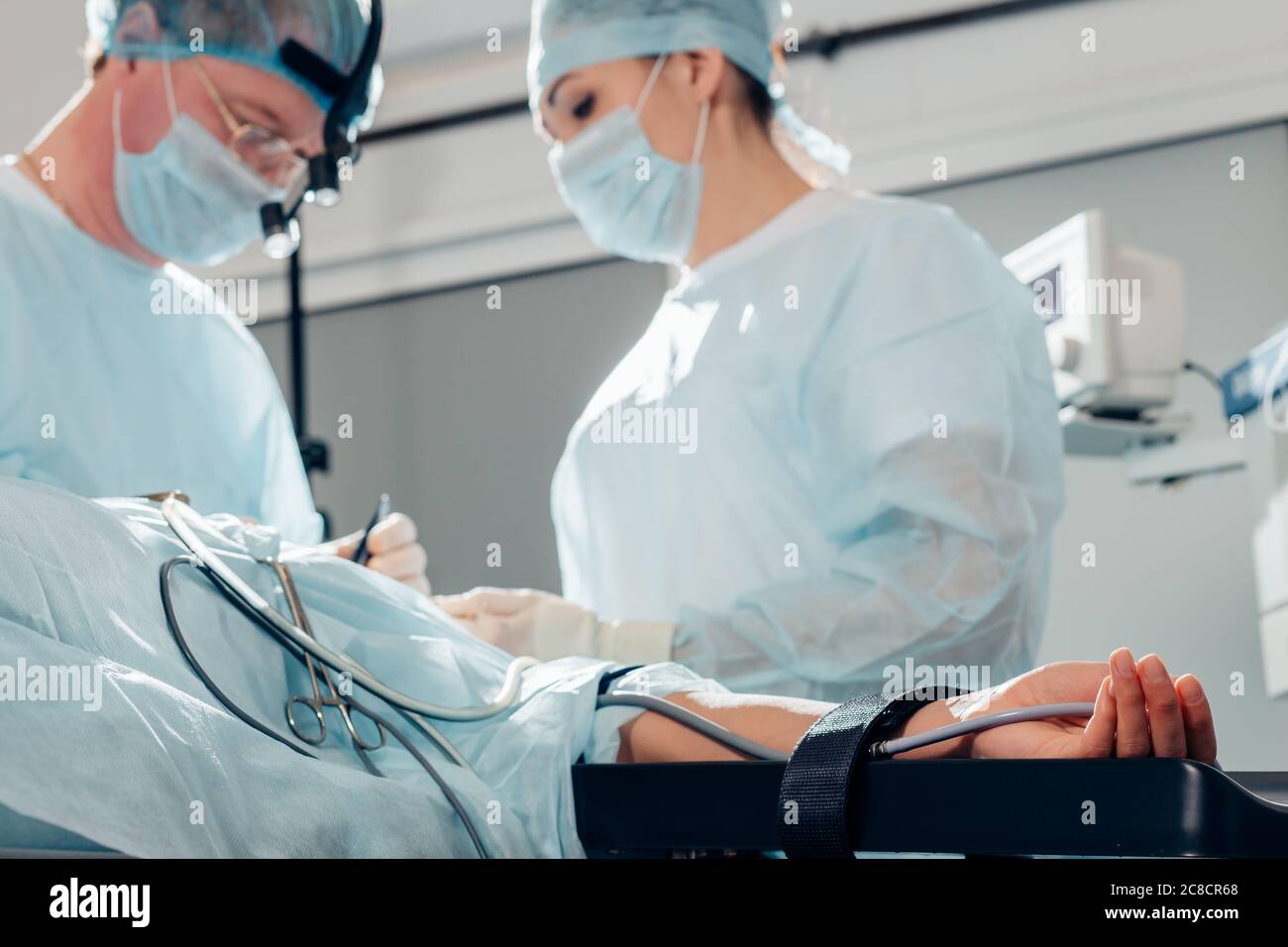 Patient lying on the bed restraint the arm with cotton on operating ...