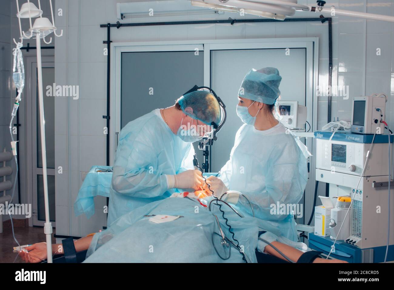 Team of surgeon in uniform perform operation on a patient at plastic ...