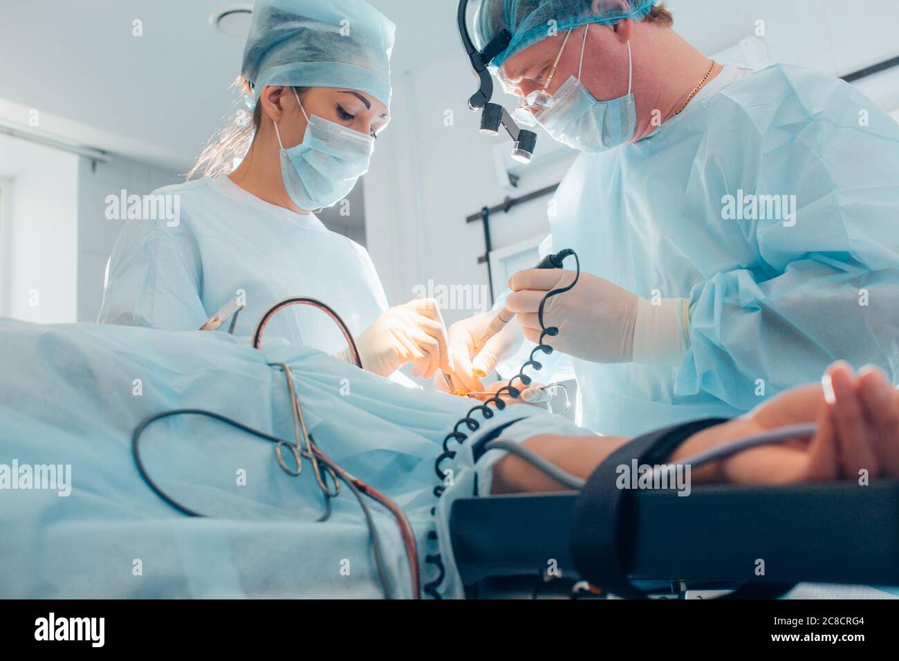 Patient lying on the bed restraint the arm with cotton on operating ...