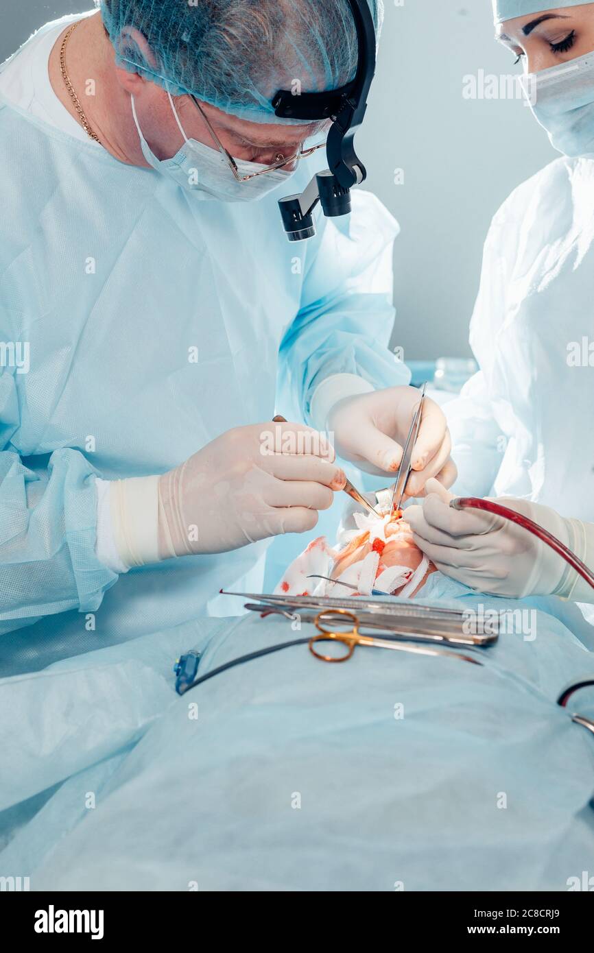 Another surgery. Surgery medical team operating in a surgery room of ...