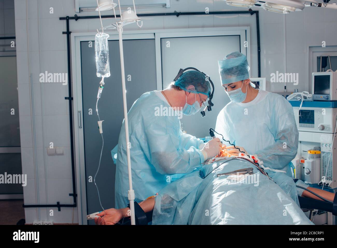 Surgeon performing cosmetic surgery on nose in hospital operating room ...