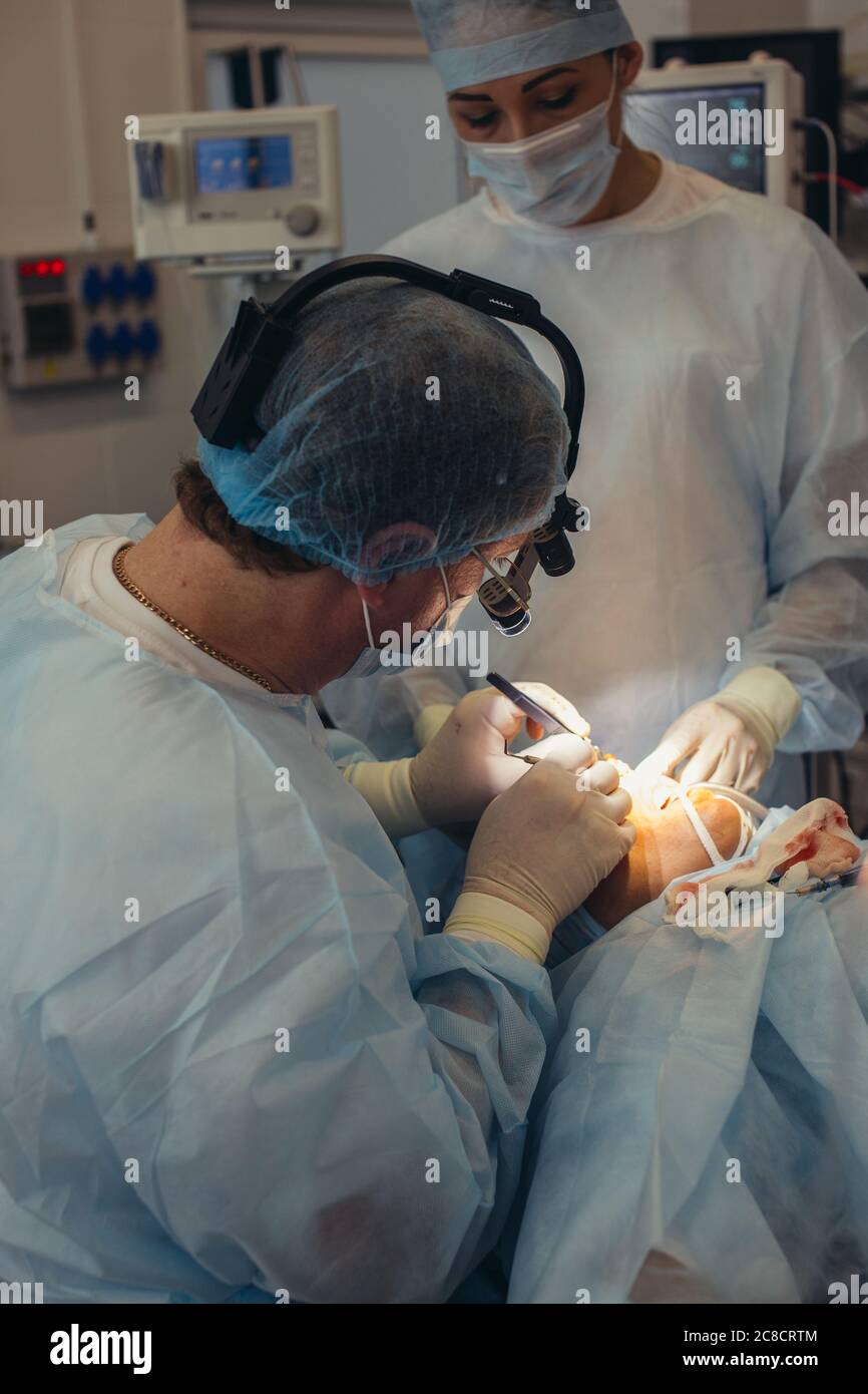 Surgery team doing plastic surgery on nose in a surgical room Stock ...
