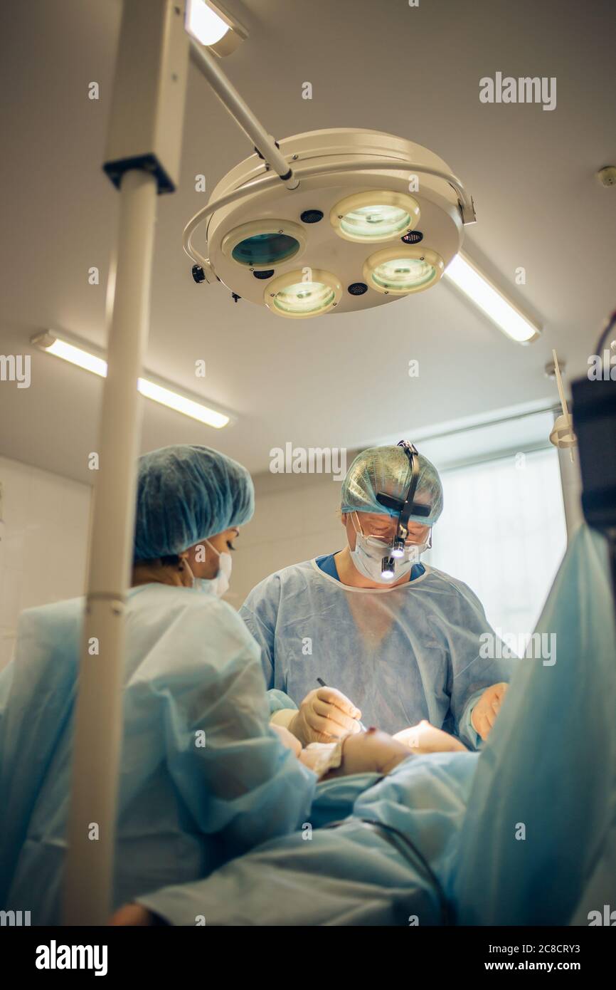 Surgery team operating in a surgical room Stock Photo - Alamy