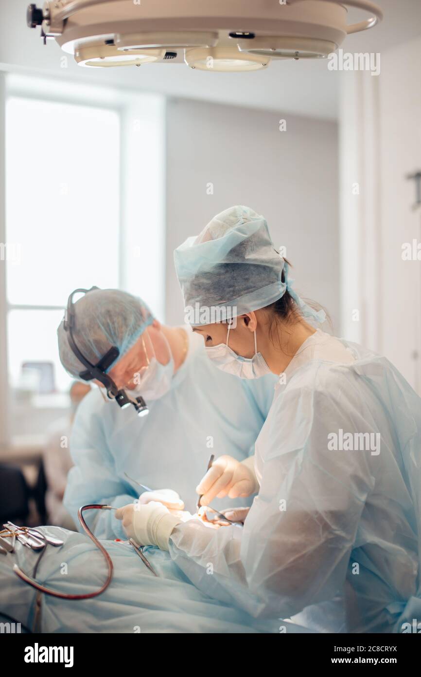 Surgery team doing plastic surgery on nose in a surgical room Stock ...