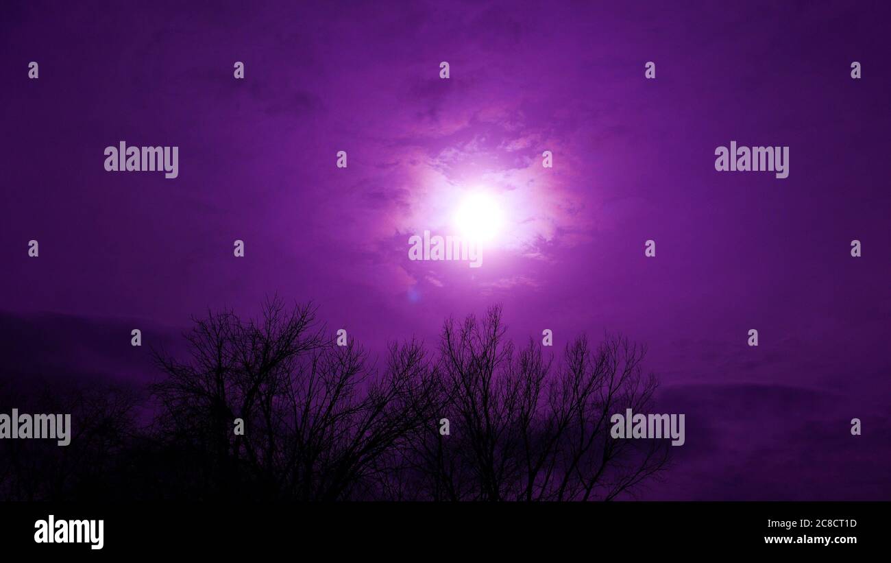 Sun shot through filter giving the sky a purple effect Stock Photo - Alamy