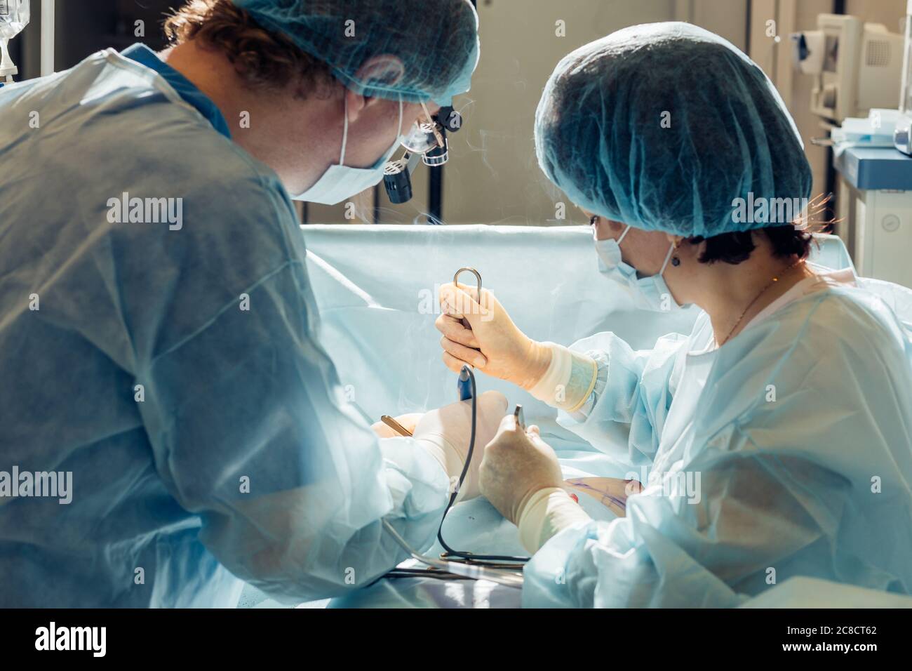 two surgeons at work in operating room. close up Stock Photo - Alamy