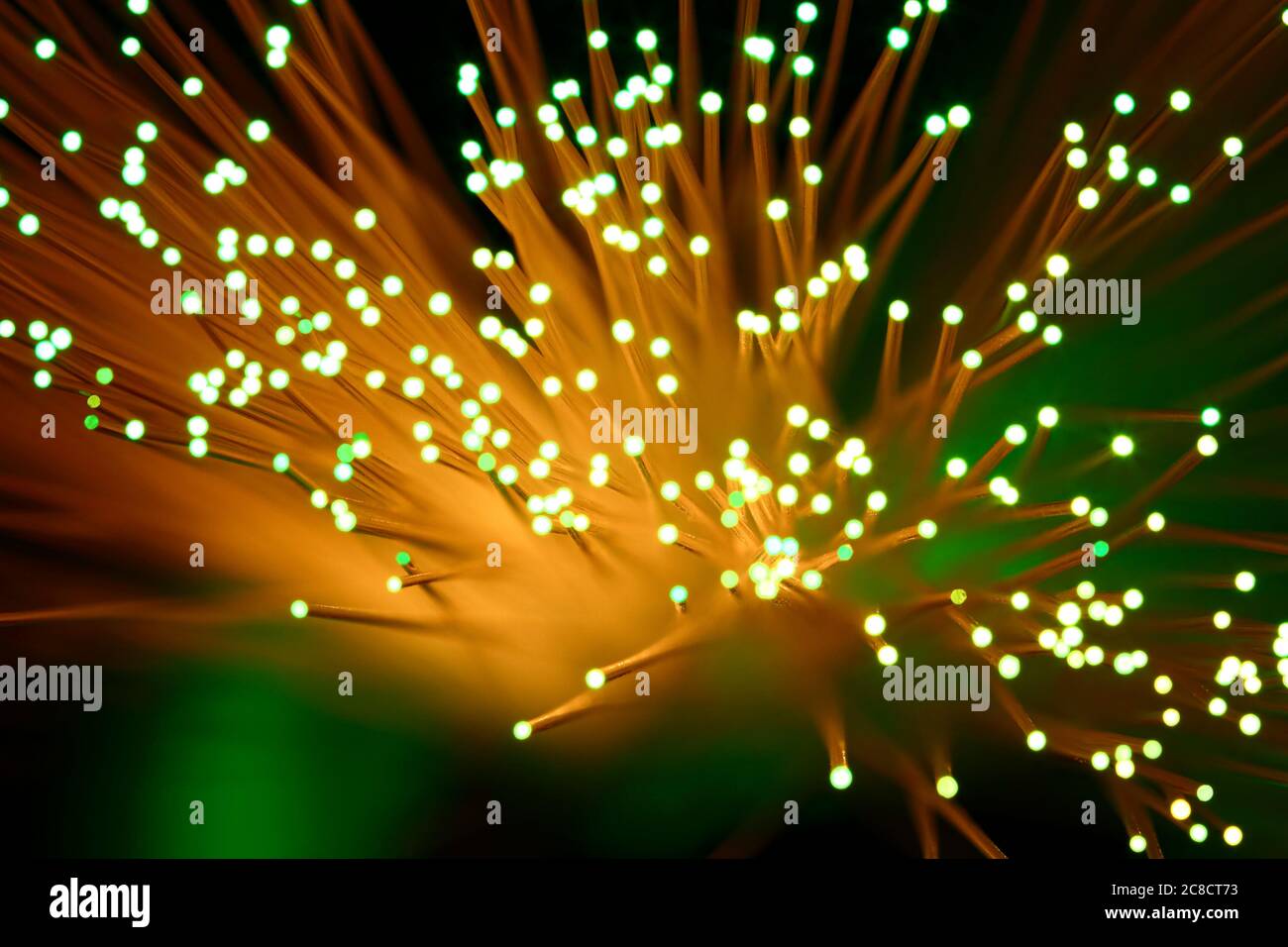 Fibre optic strands with light passing through creating a colourful ...