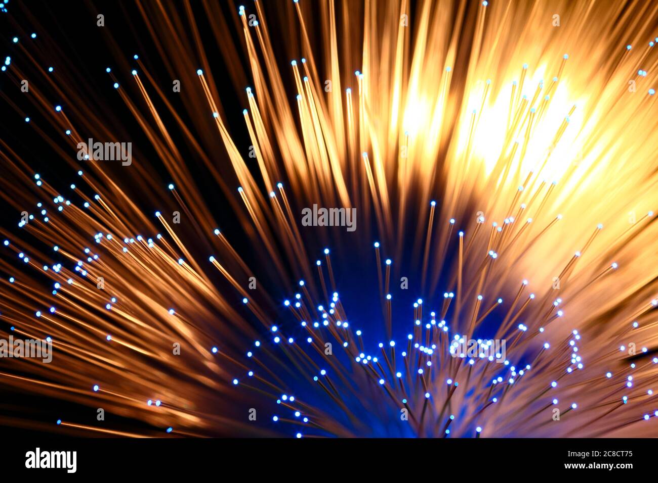 Fibre optic strands with light passing through creating a colourful ...