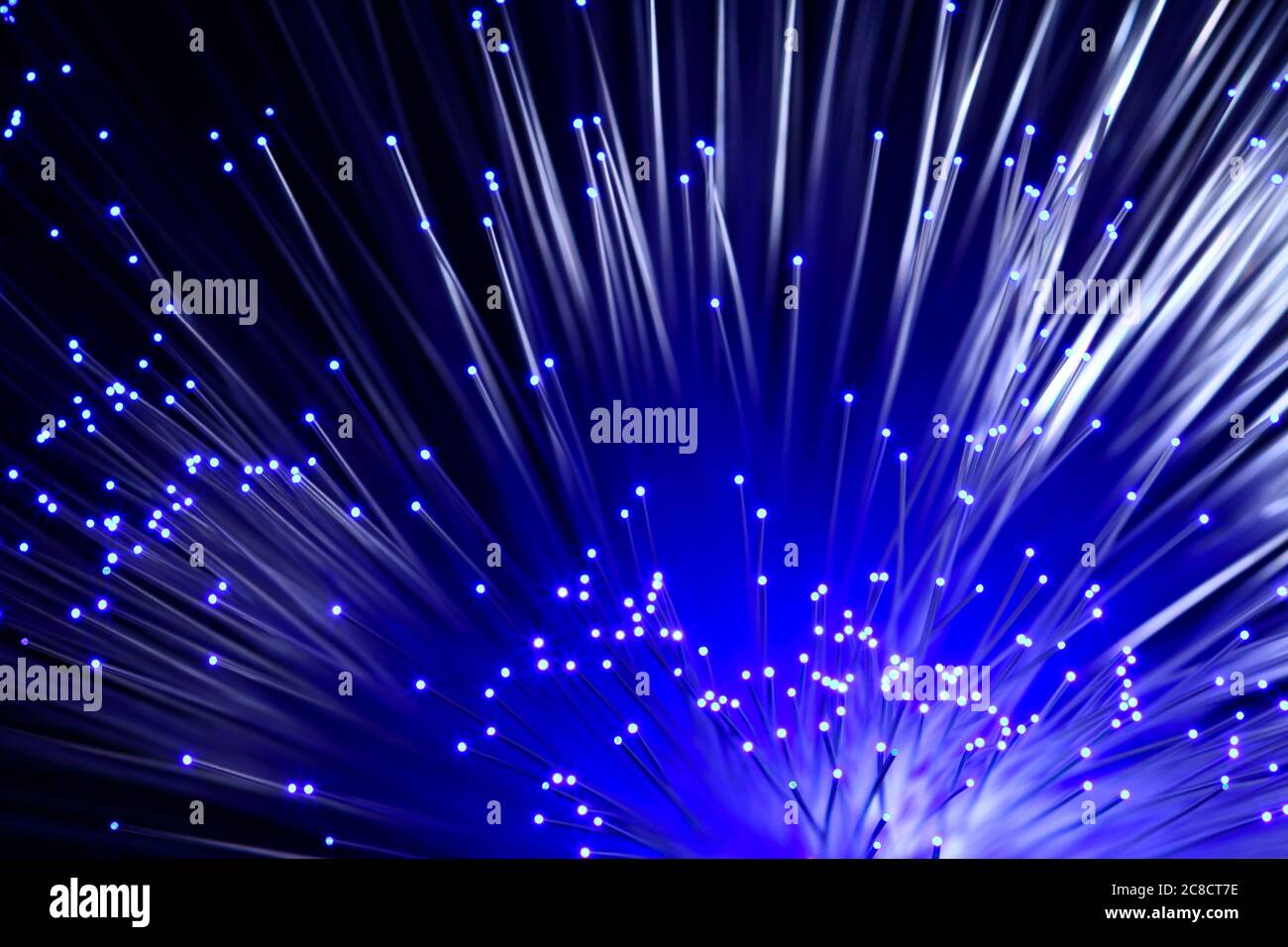 Fibre optic strands with light passing through creating a colourful ...