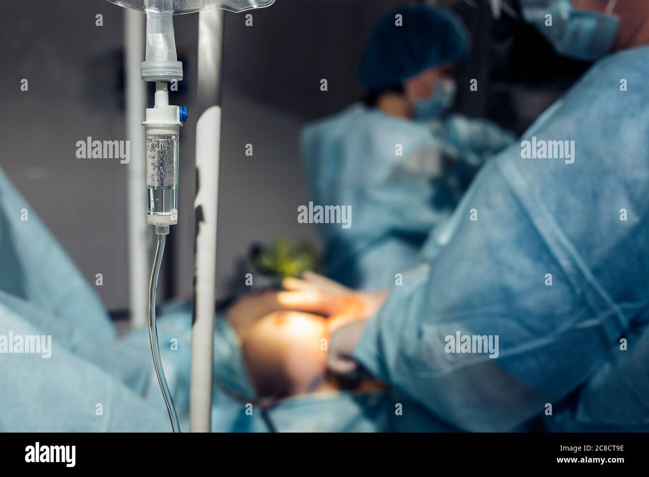 Doctor's hand and infusion drip in hospital on blurred background Stock ...