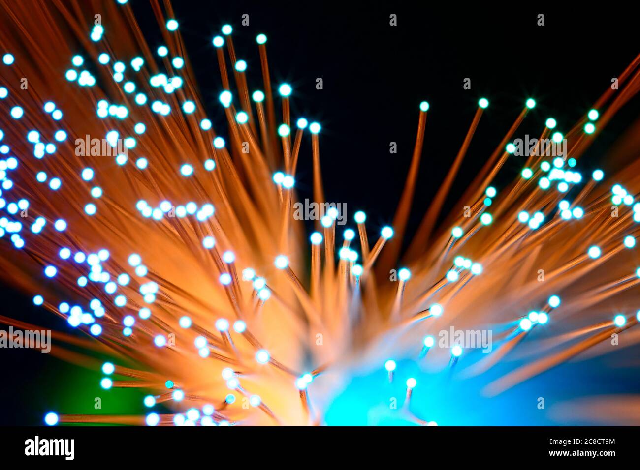Fibre optic strands with light passing through creating a colourful ...