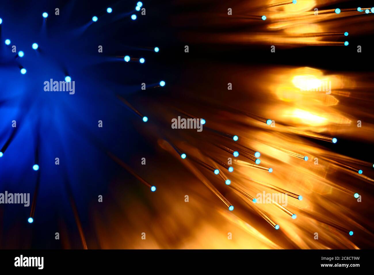 Fibre optic strands with light passing through creating a colourful ...