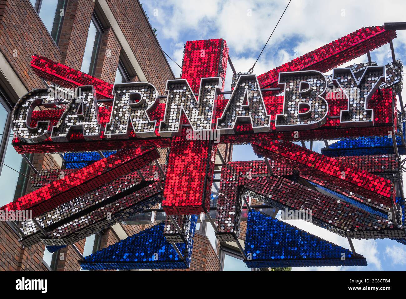 Carnaby sign featuring the Union Jack design hanging above Carnaby ...