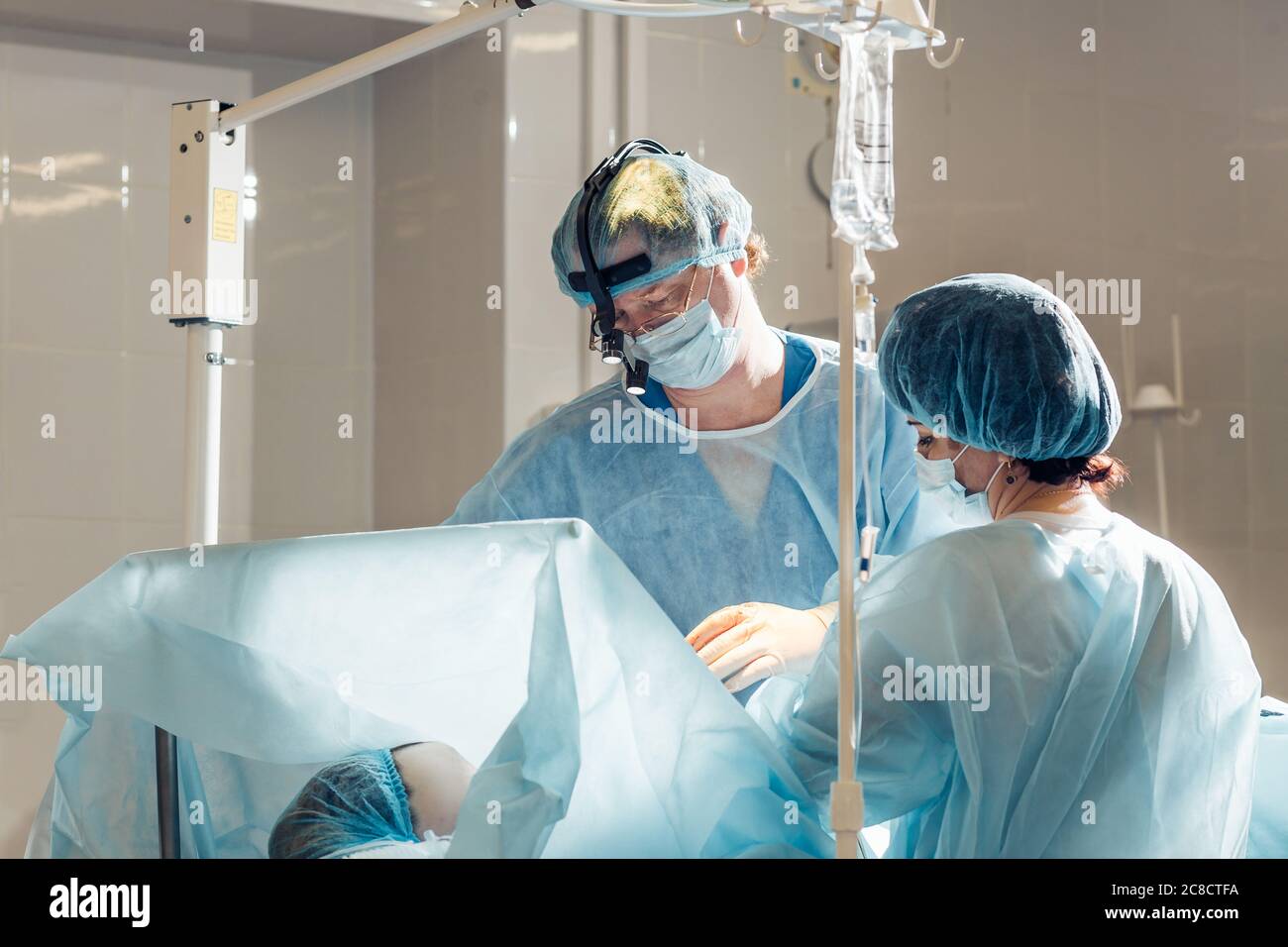 surgery, healthcare, medicine and people concept - nurse assisting ...
