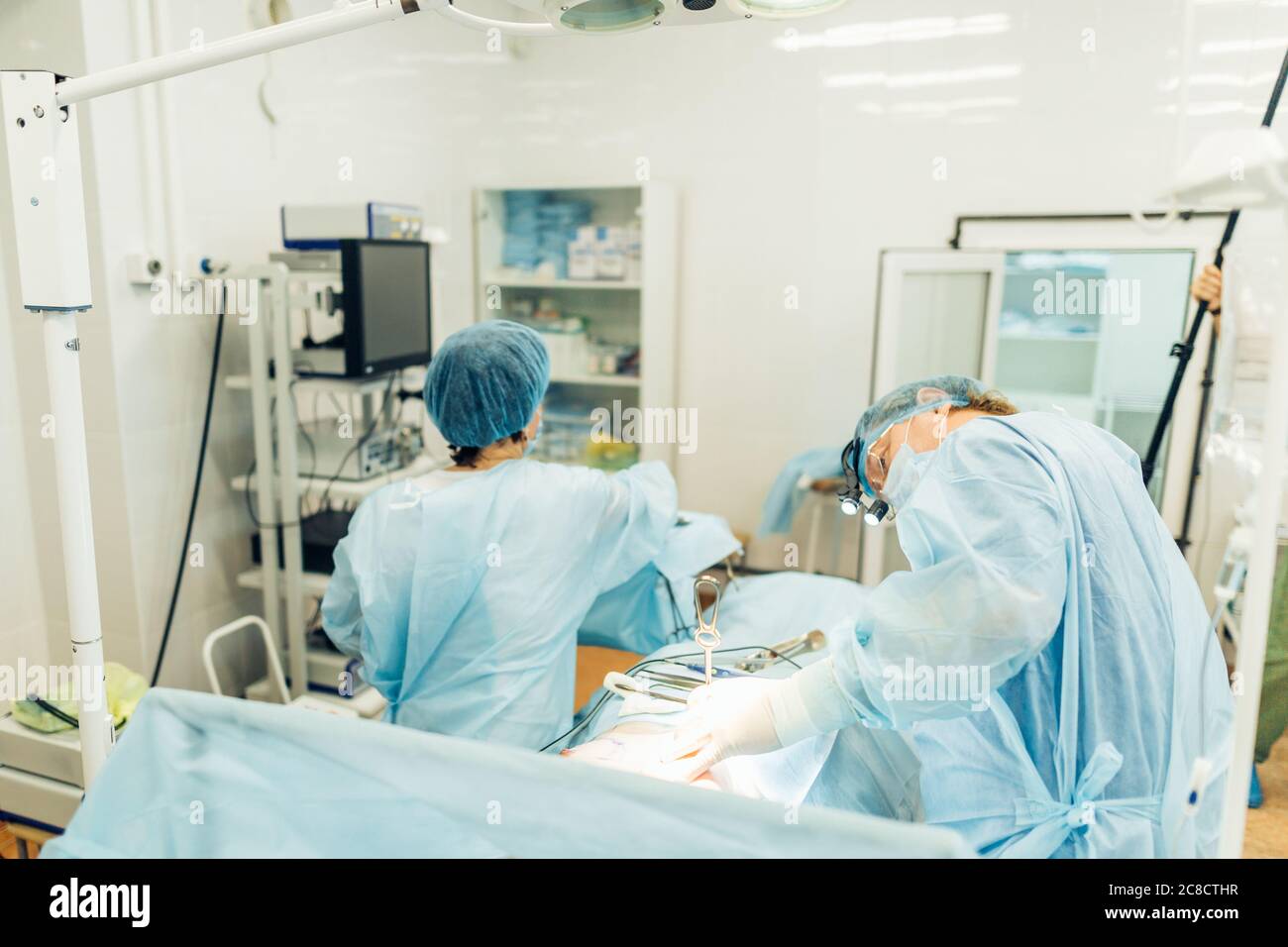 Surgeon taking scissors from the table Stock Photo - Alamy