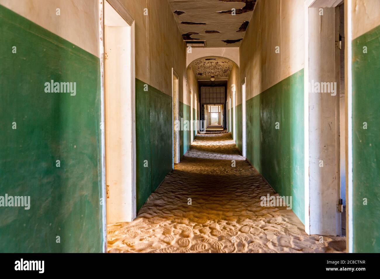 Inside shot of an old abandoned building with weathered doors and walls ...