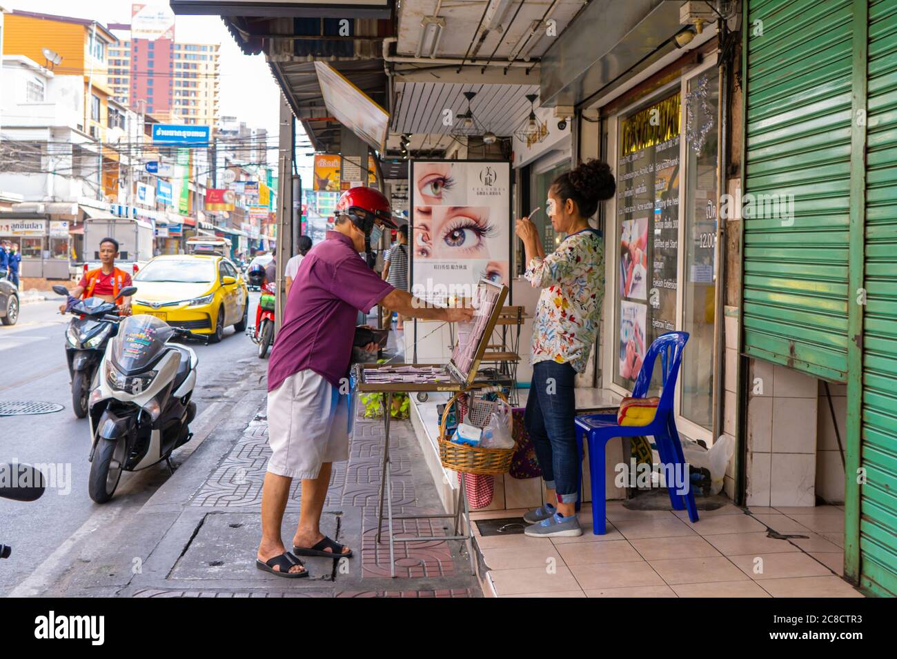 A man buys a lottery ticket on a street counter. Asian traditions Stock ...