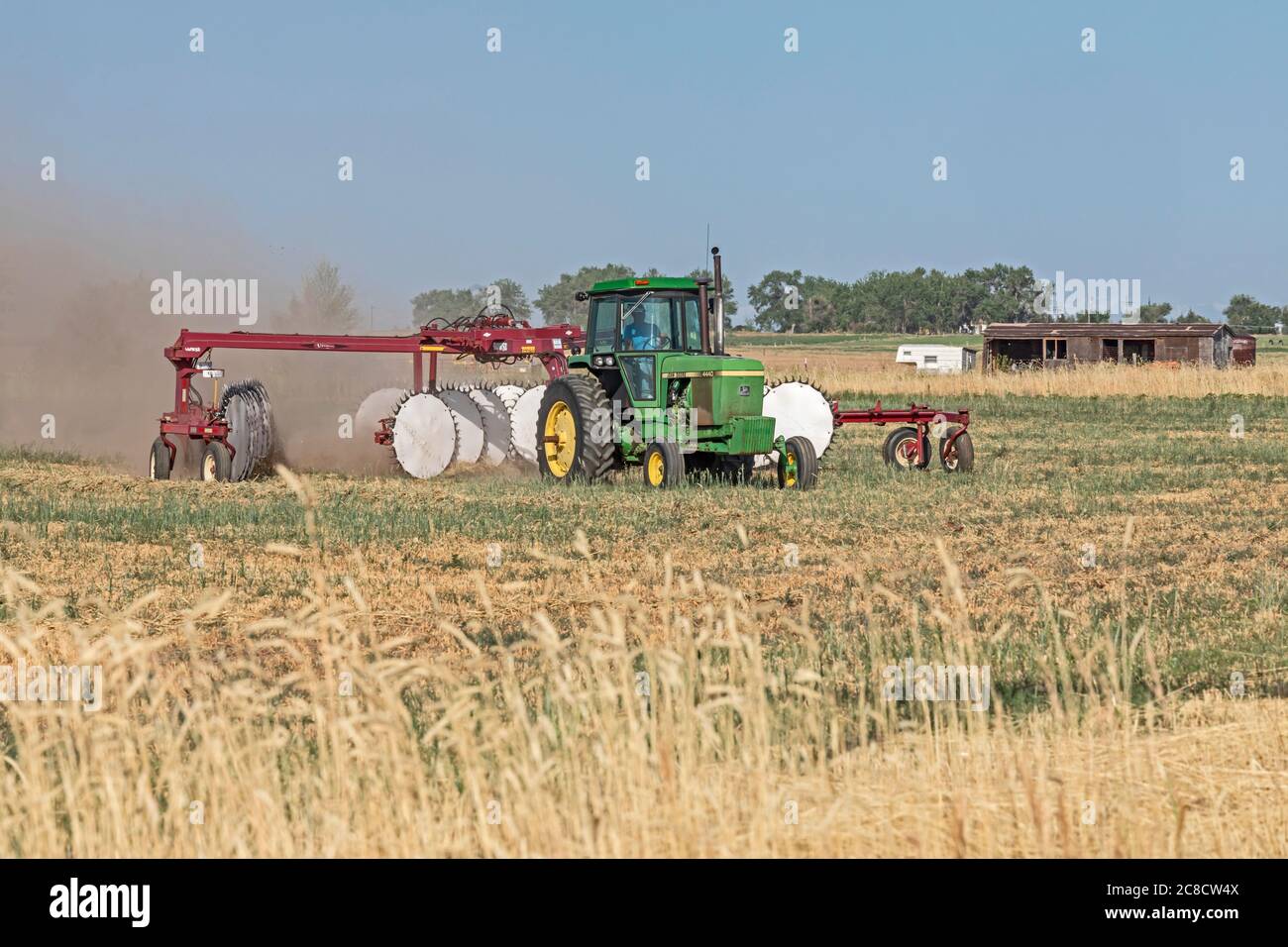 Hudson, Colorado - A farmer pulls a Rouse V-Rake through a field in ...
