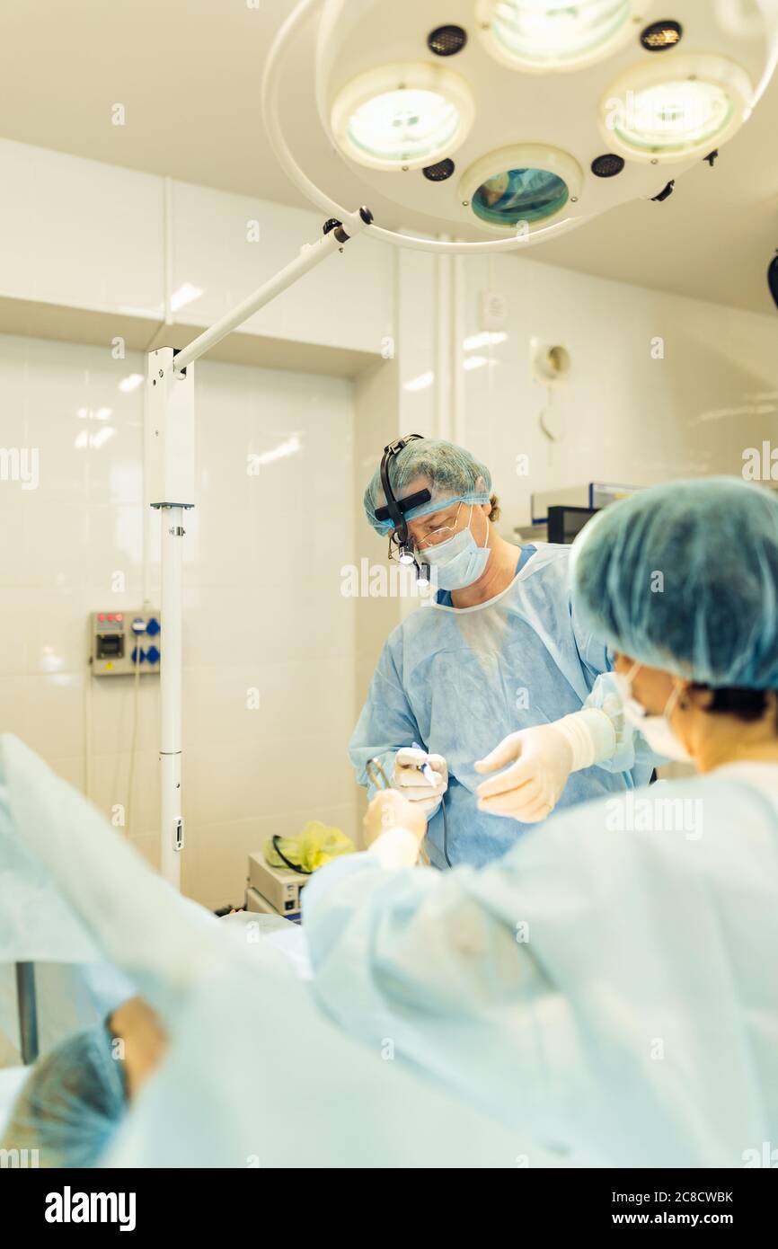 Surgery team operating in a surgical room Stock Photo - Alamy
