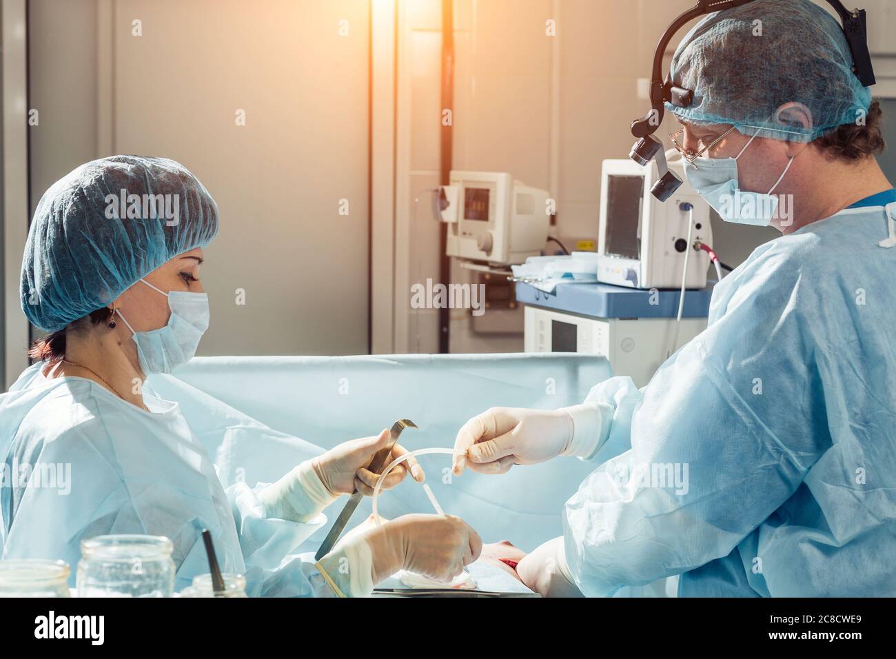 two surgeons at work in operating room. close up Stock Photo - Alamy