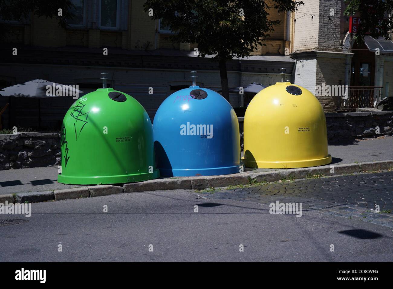 Three colored bins for sorting waste located in the city on the street ...