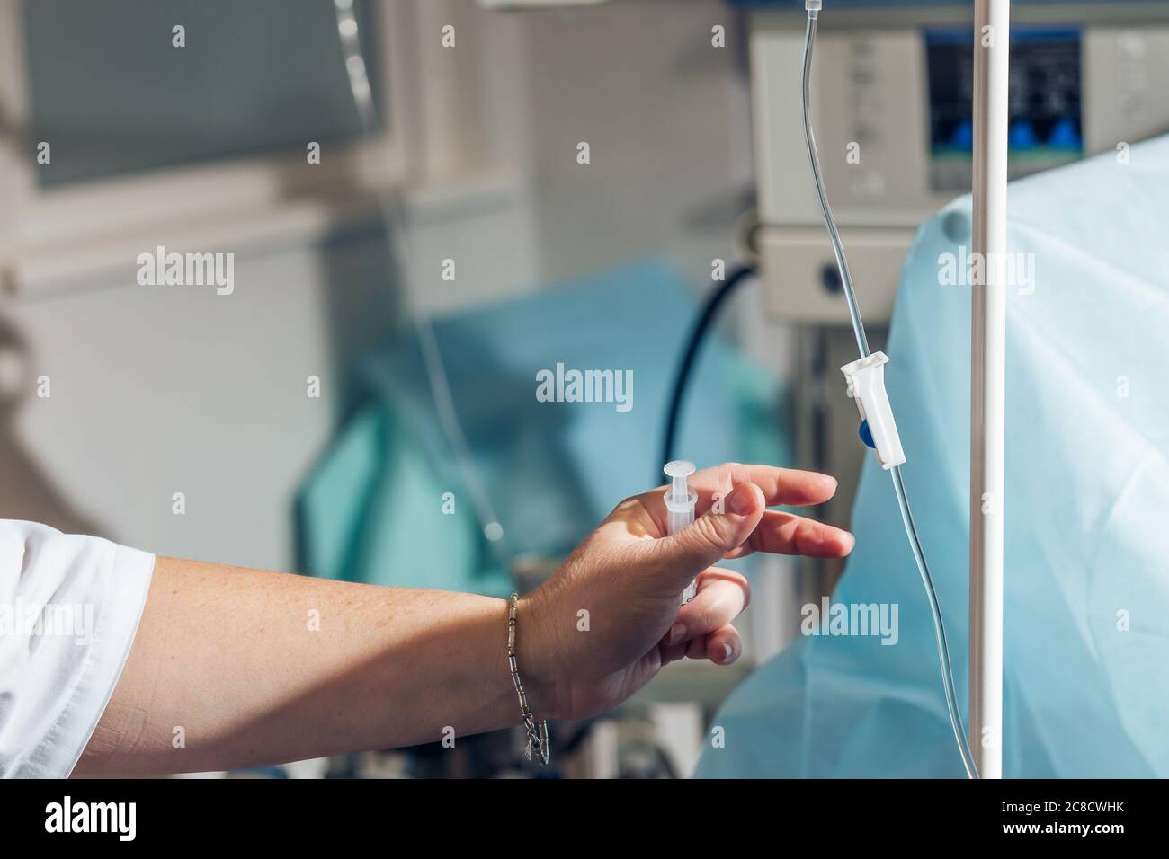 Doctor's hand and infusion drip in hospital on blurred background Stock ...