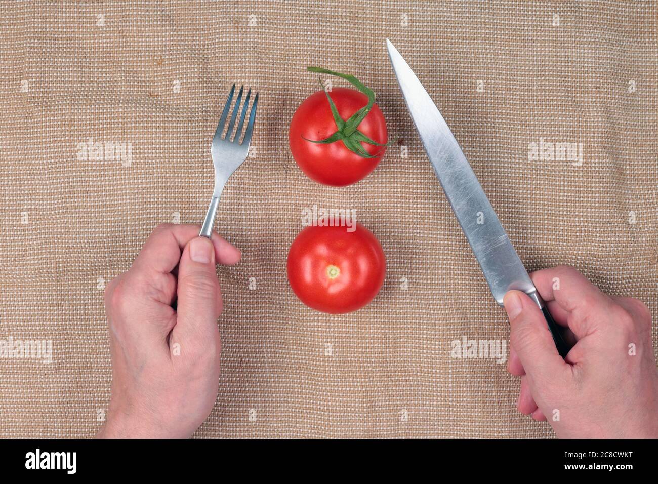 Elderly village man eating tomatoes with a knife and fork Stock Photo ...