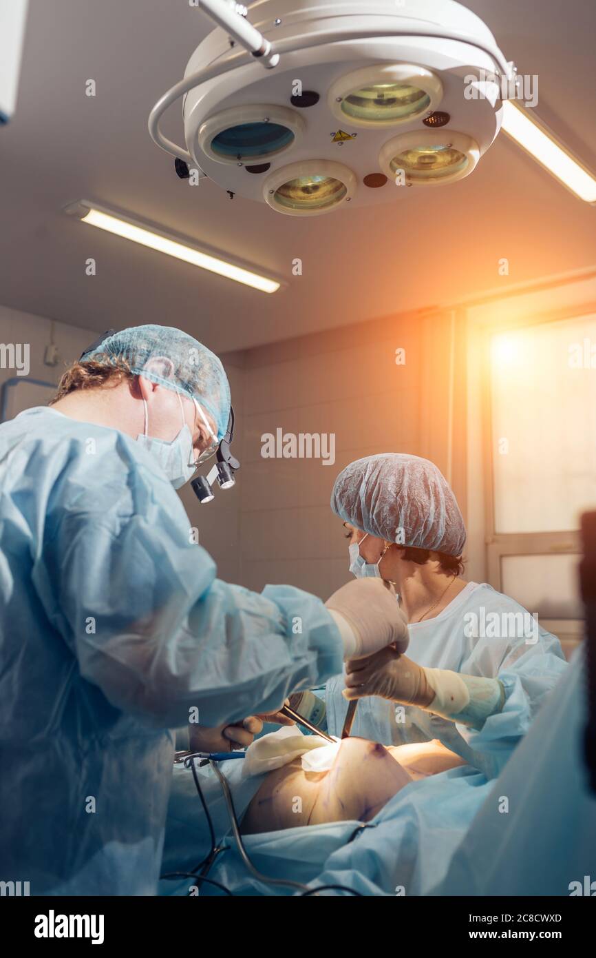 Surgery team operating in a surgical room Stock Photo - Alamy