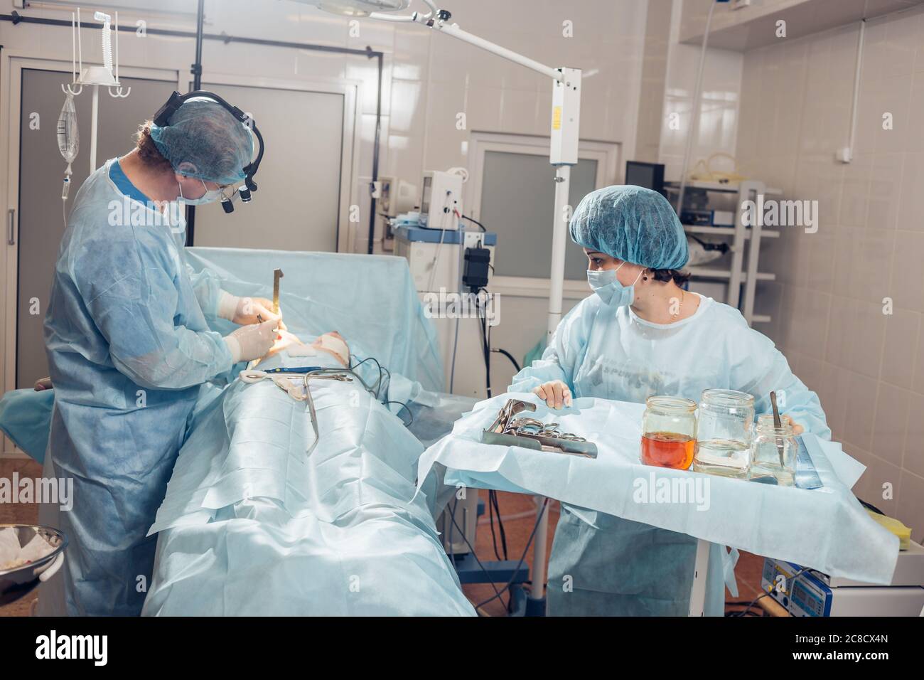 Surgeon taking scissors from the table Stock Photo - Alamy
