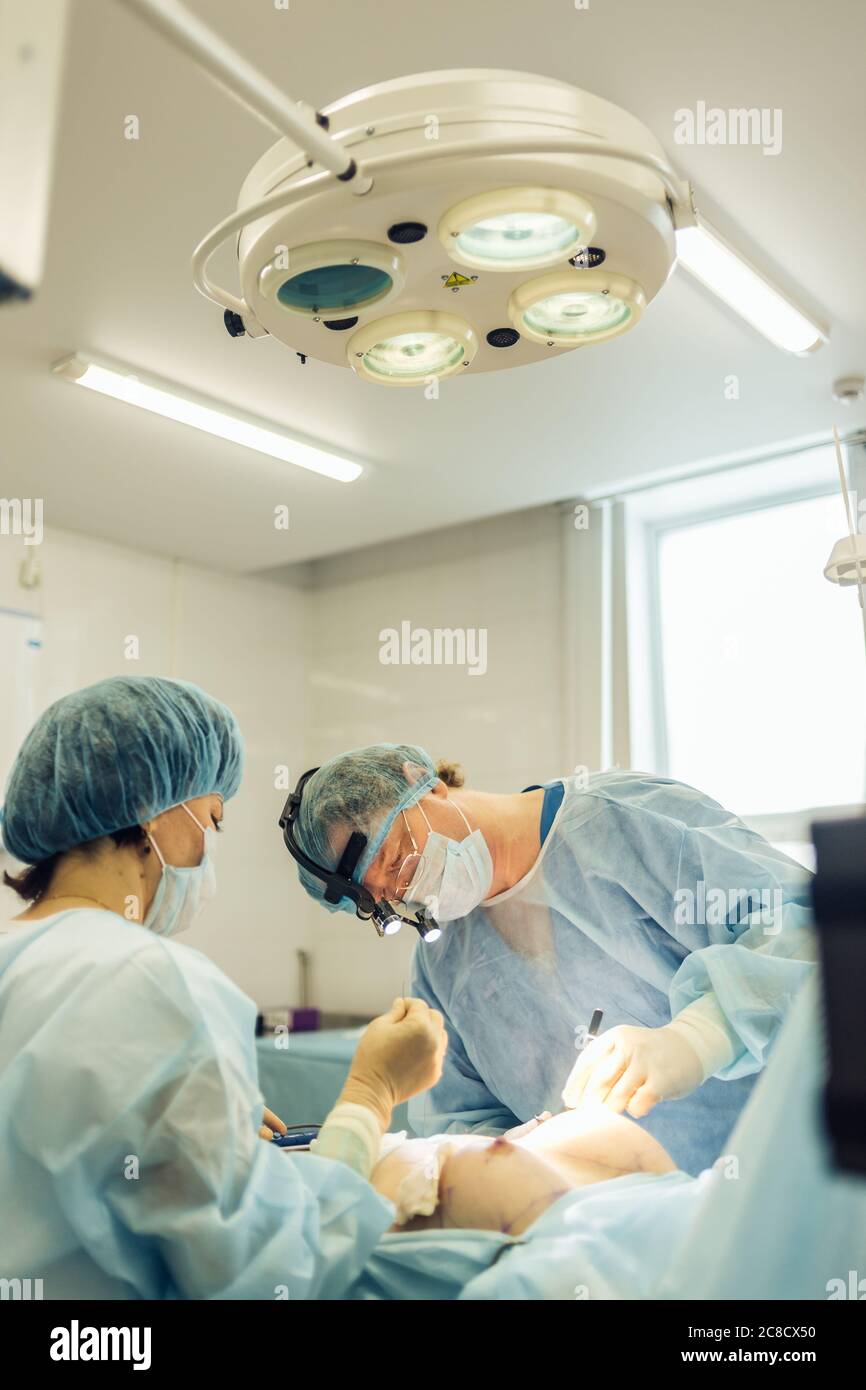 Surgery team operating in a surgical room Stock Photo - Alamy