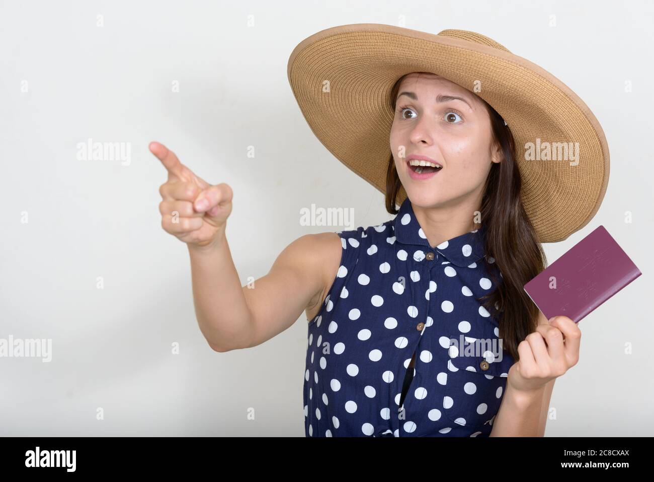 Portrait of young beautiful tourist woman against white background ...