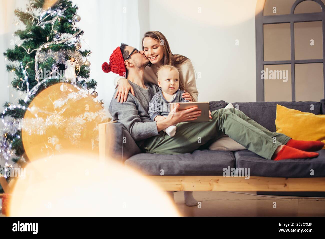 Gathered around decorated tree hi-res stock photography and images - Alamy