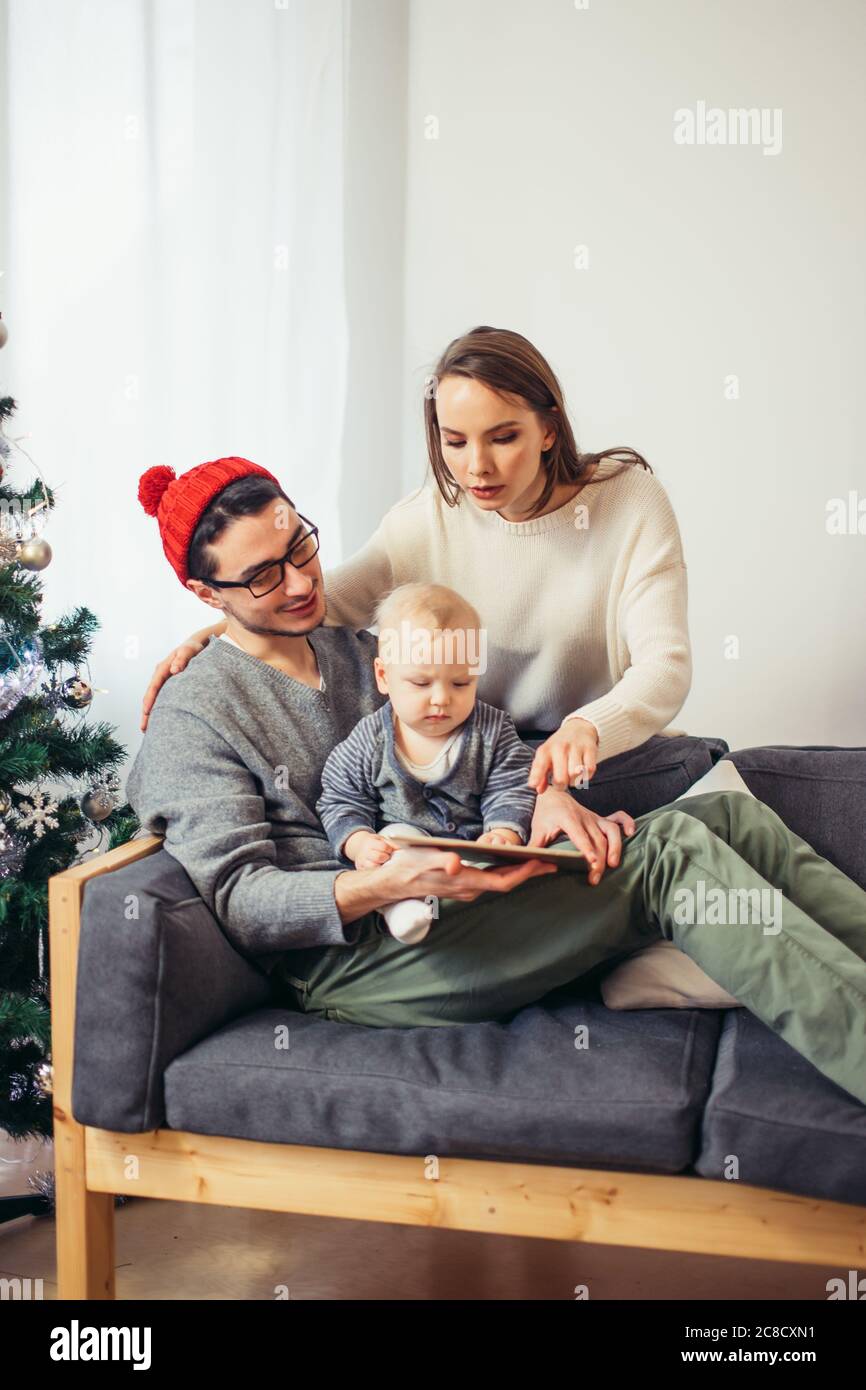 Family Sitting Around Christmas Tree High Resolution Stock Photography ...