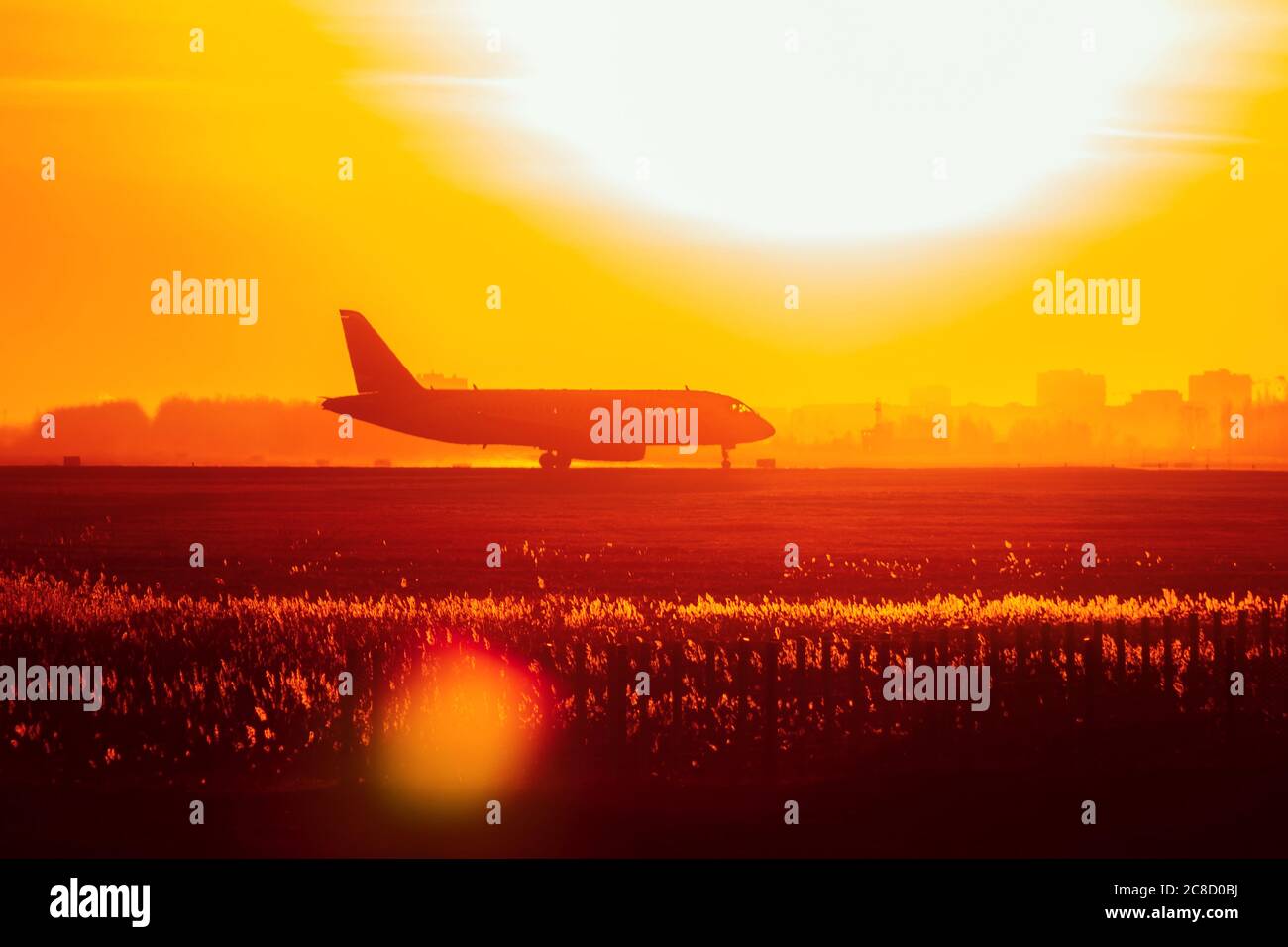 sunset plane silhouette on the runway sun beam start takeoff Stock ...