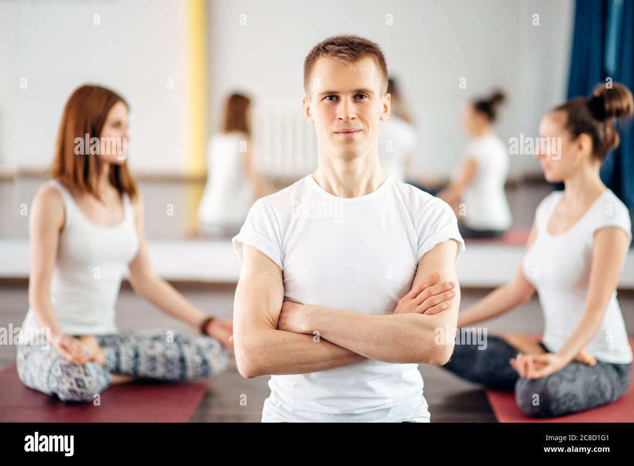 man in the Lotus position sitting on a background of two women Stock ...