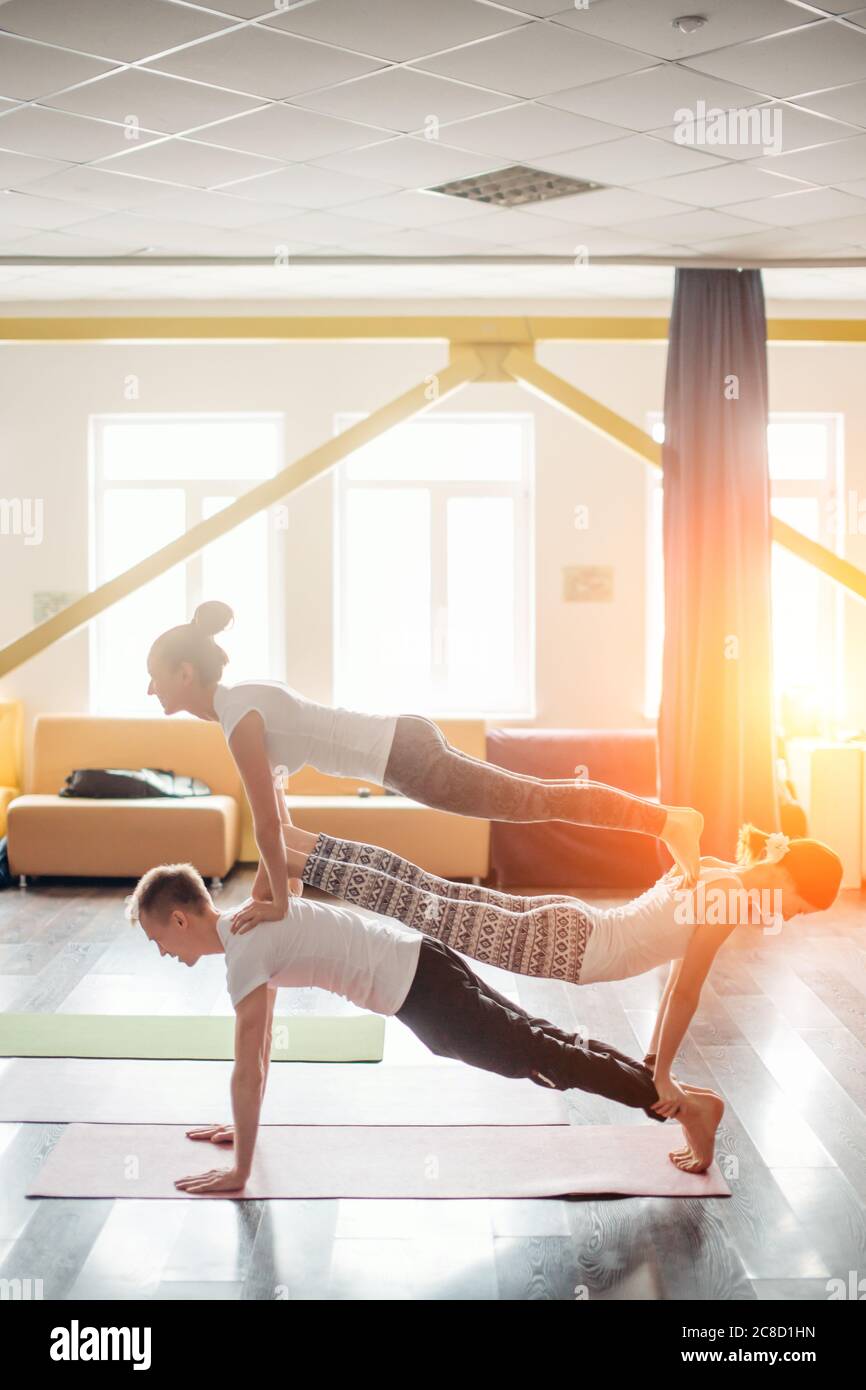 three people are planking on each other Stock Photo - Alamy