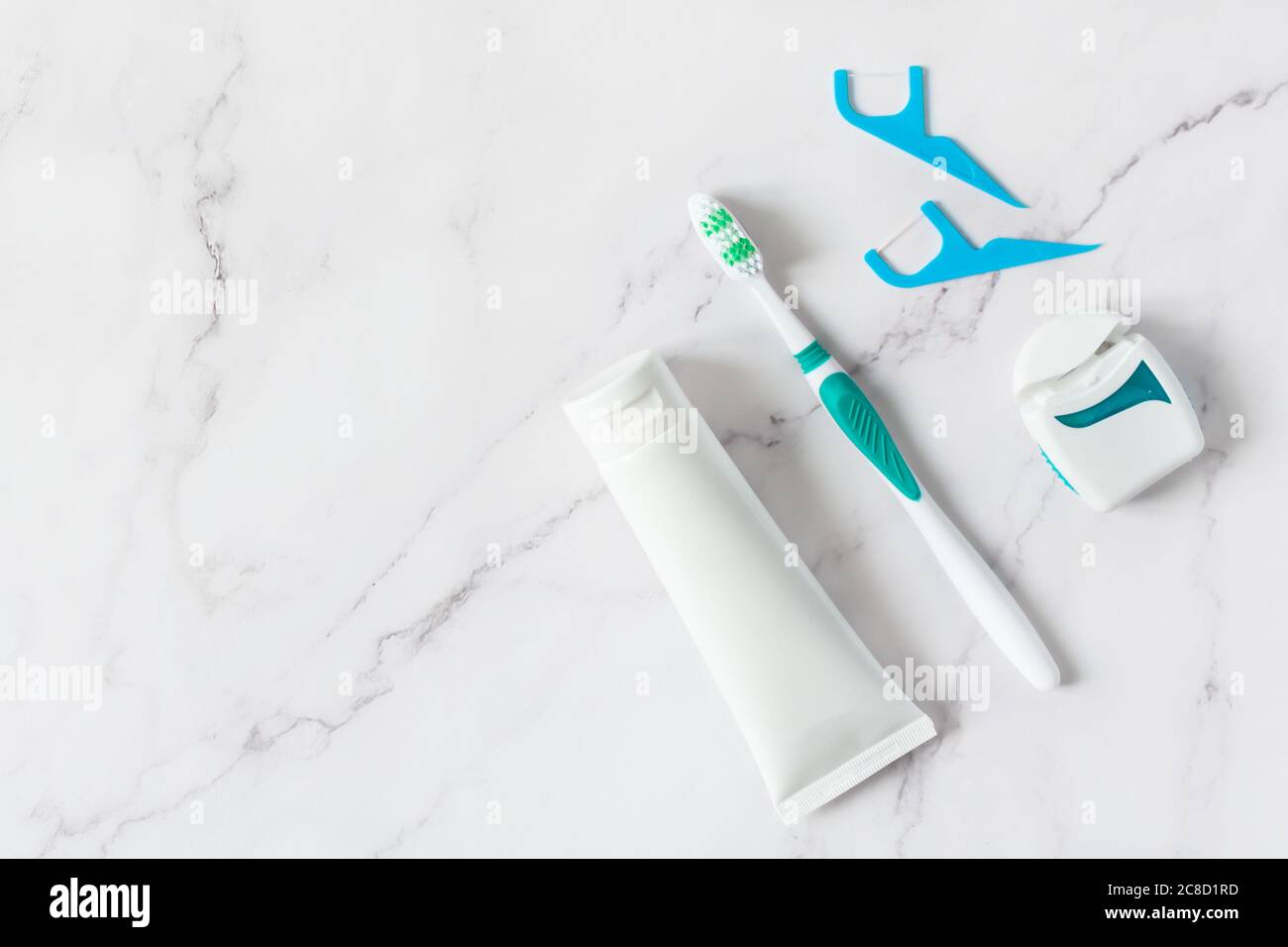 Toothbrush, toothpaste and dental floss top view on white marble ...