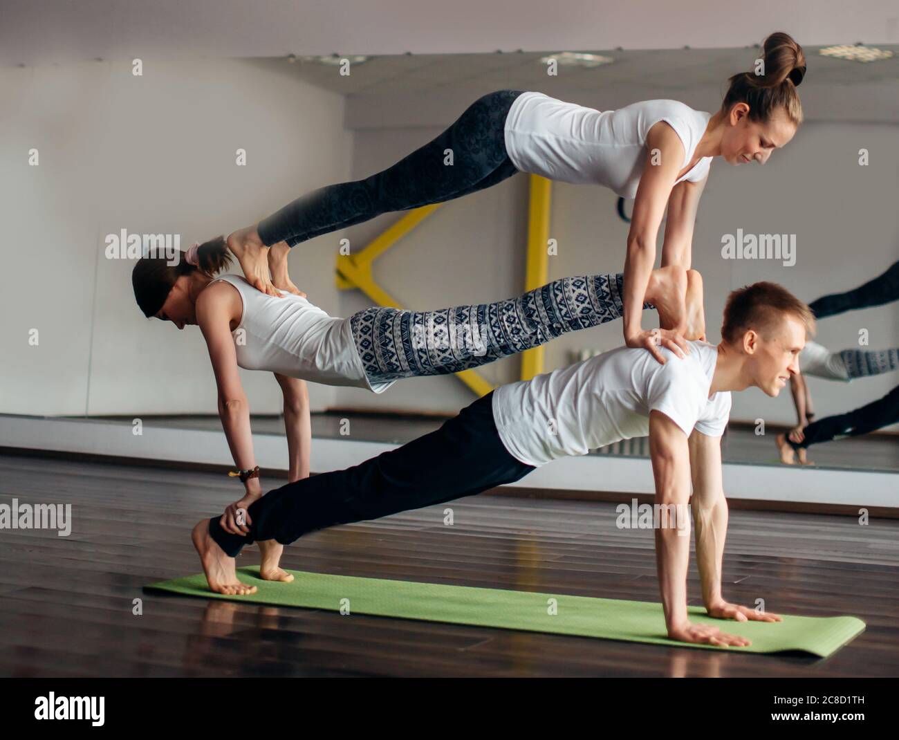 three people are planking on each other Stock Photo - Alamy