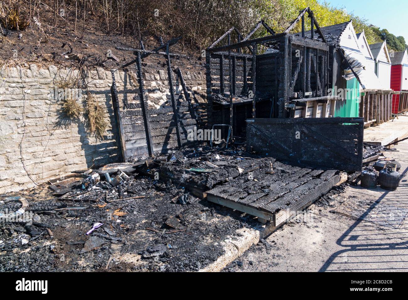 Charred remains of beach huts destroyed in fire at West Cliff beach ...