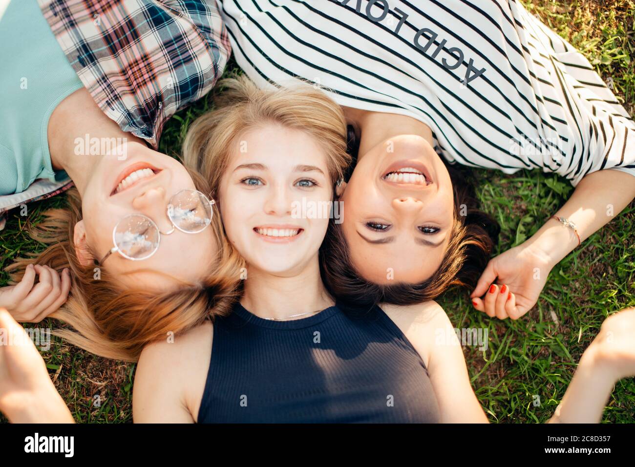 Having best time with friends. Top view of a group of students lying on ...